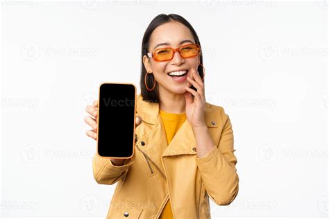 Enthusiastic Asian Female Model Showing Smartphone App Interface Enthusiastic Asian Female Model Showing Smartphone App Interface