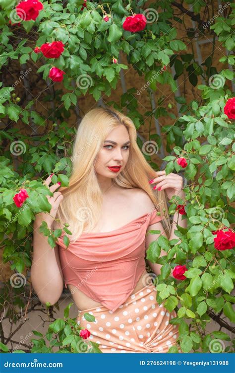Beautiful Woman With Long Blonde Hair And Red Lips Wearing Pink Clothes