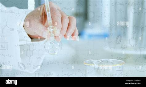 Caucasian Senior Male Scientist Holding Flask Examining A Clear Liquid Stock Photo Alamy