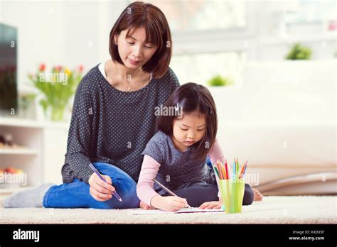 Pretty Happy Japanese Mother Play And Draw With Her Cute Little