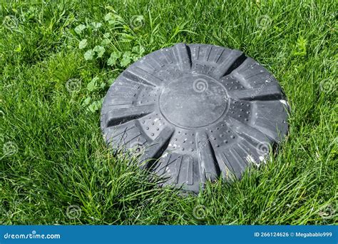 Sewer Hatch On Green Lawn Round Black Plastic Cover To Close Access To