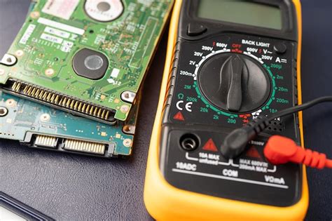 Premium Photo Multimeter With Main Board Maintenance Repairing And Checking Computer Hardware
