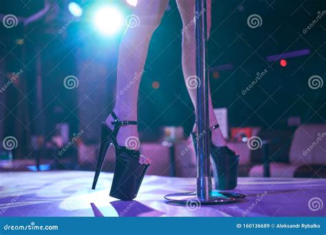 Young Woman Pole Dancing Striptease With Pylon In Night Club Beautiful