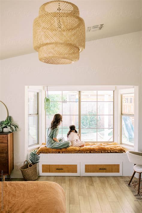 Mom And Daughter Sitting In Bay Window In Home By Stocksy Contributor Daniel Kim Photography