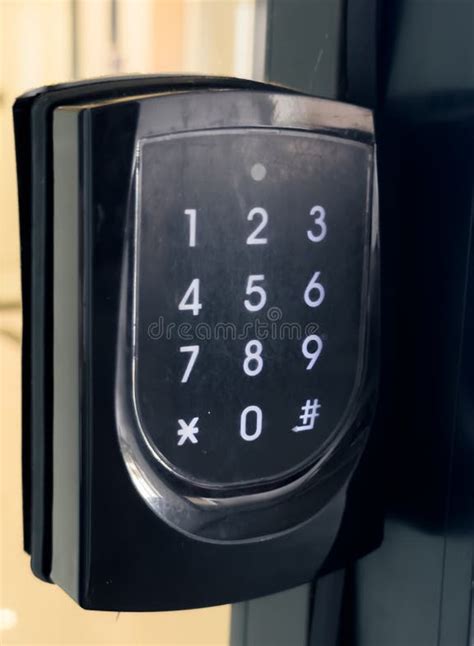 a close up of a black keypad door lock with a numerical keypad stock