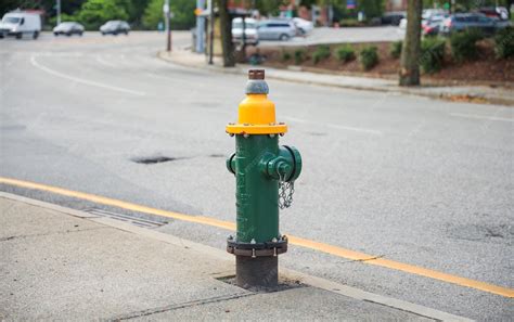Premium Photo A Green And Yellow Fire Hydrant With A Yellow Top