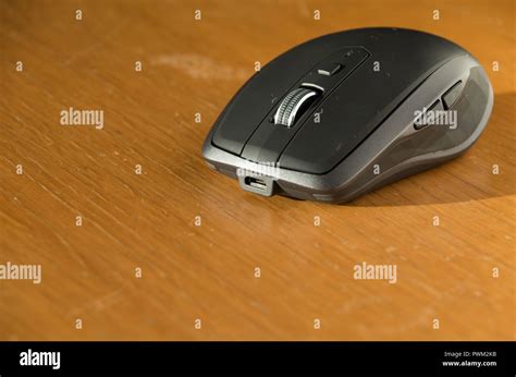 Wireless Mouse With Omnidirectional Scroll Wheel And Side Buttons Isolated On A Table Stock