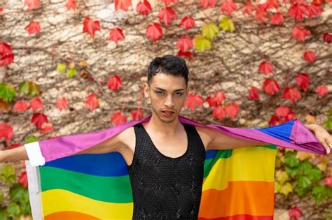 Premium Photo Portrait Of Biracial Transgender Man Holding Rainbow