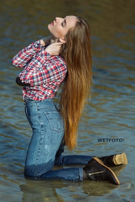 Swimming By Beautiful Girl In Soaking Wet Blue Jeans And Shoes On Lake