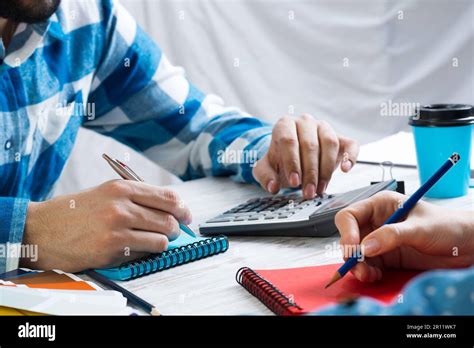 Developers Calculating Project At Desk Stock Photo Alamy
