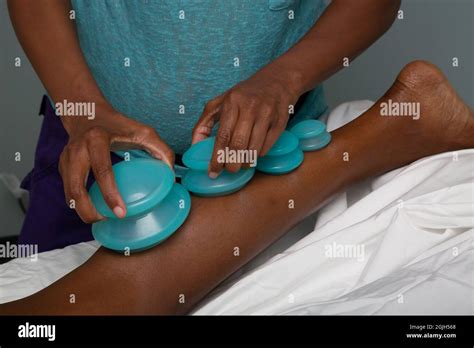 A Black Female Massage Therapist Working On A Black Female Client Stock