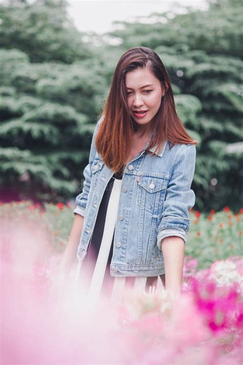 A Woman Standing In A Pink Flower Garden Stock Image Image Of
