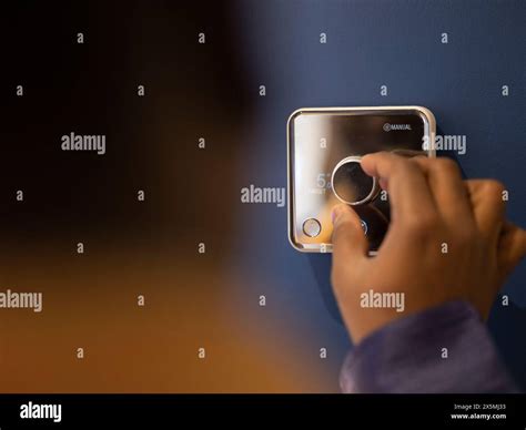 Man Using Thermostat At Home Stock Photo Alamy