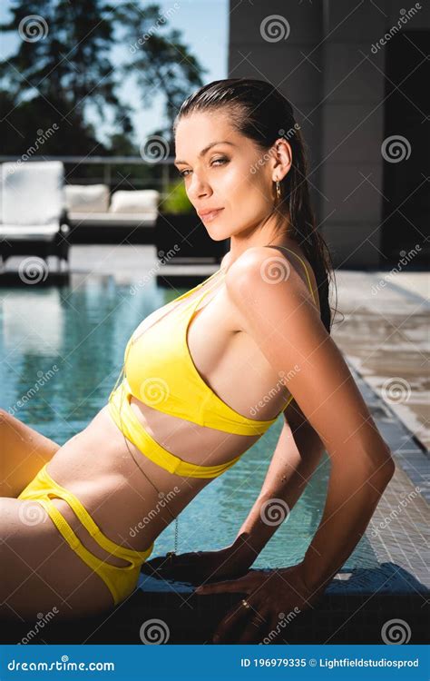 Seductive Woman In Swimming Suit Posing Near Pool On Resort Stock Image