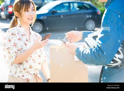 Woman Receiving A Delivery Stock Photo Alamy