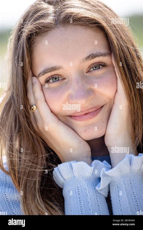 Happy Beautiful Girl Holding Her Cheeks With A Laugh Looking At The