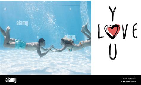 Couple Holding Hands Swimming Underwater High Resolution Stock