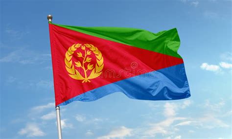 Eritrean National Flag With Olive Wreath Symbol Waving In Sky Stock