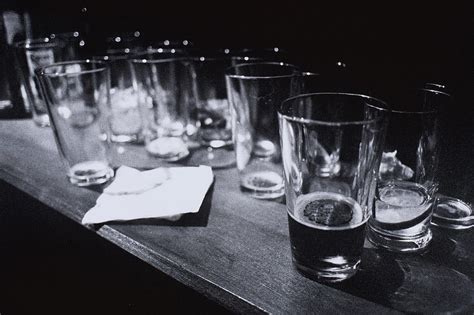 Empty Beer Glasses On Table By Henry Horenstein