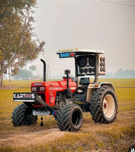 Red Tractor Parked On Grass Field