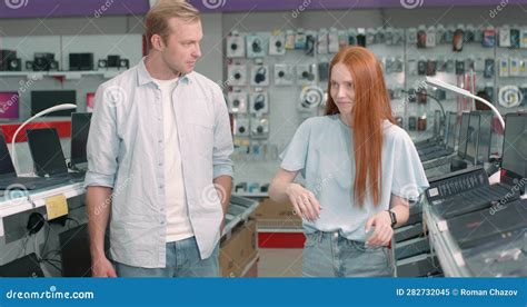 Handsome Man And Redhead Woman Talking While Choosing A Computer Stock Video Video Of