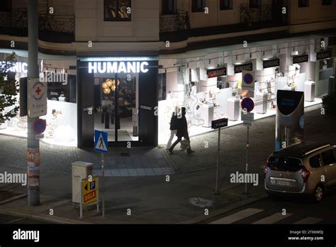 Two Man Walks In Front Of The Humanic Store Vienna Austria At Night In Winter Photographed