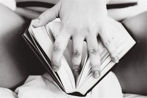 The Fingers Of A Woman S Hand Slide Between The Pages Of The Book