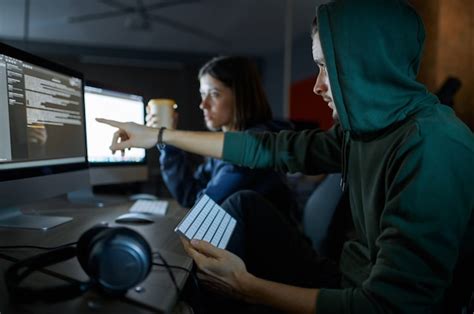 Premium Photo Male And Female Hackers Works On Computers In Darknet Dangerous Teamwork