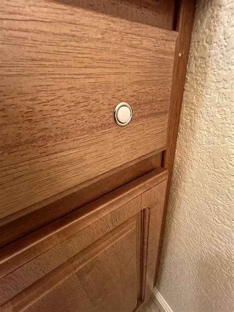 Half Inch Wide Pushable Button That Is Built Into The Bathroom Vanity