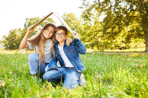 Hermano Y Hermana Con Techo Sobre La Cabeza Imagen De Archivo Imagen
