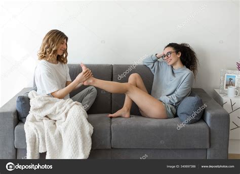 Relaxed Lesbian Couple Home One Young Woman Giving Feet Massage Stock