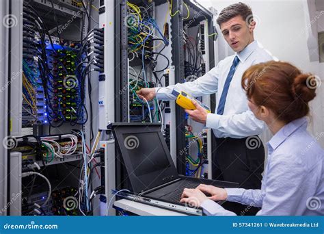 Team Of Technicians Using Digital Cable Analyser On Servers Stock Image