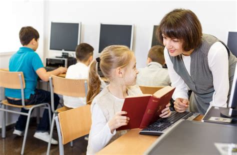 Woman Teacher Helping Tween Girl In Computer Class Stock Image Image