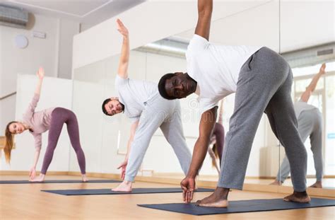 Men And Woman Doing Windmill Exercise In Gym Stock Image Image Of Kenyan Muscle 248565383