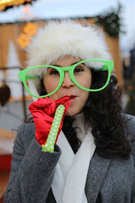 Woman Celebrating New Years Eve With Party Horn Blower Stock Photo