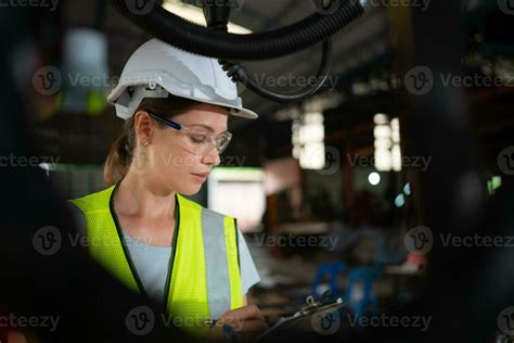 Female Electrical Engineer With The Mission Of Installing A Robot Arm Electrical System 25772780