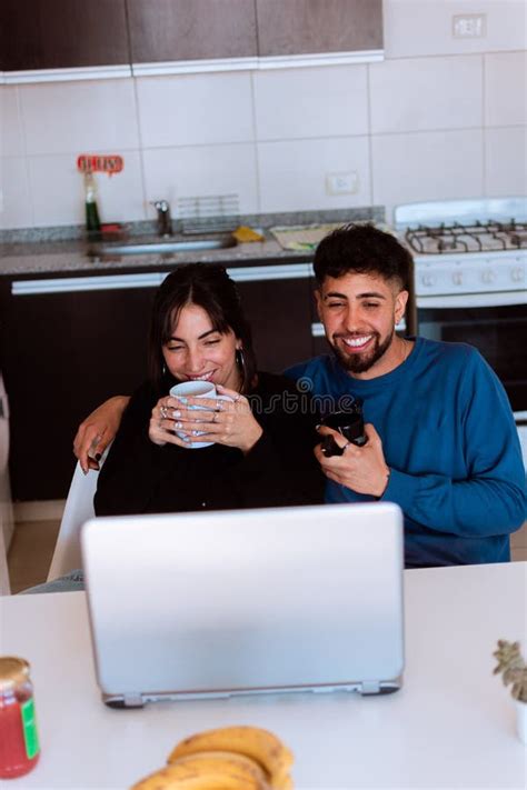 Bela Foto De Casal Hispânico Sentado E Tomando Café Juntos Na Cozinha Na Argentina Imagem de