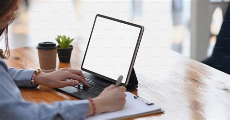 나무 사무실 책상에 앉아 컴퓨터 태블릿으로 작업하고 노트북에 메모를 하는 사업가의 잘린 사진 사진 Unsplash의 비즈니스 사람 이미지