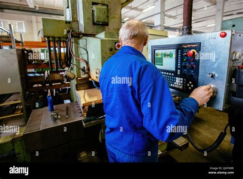 Factory Engineer Adjusting Operation Parameters Of Cnc Lathe Machine