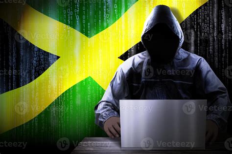 anonymous hooded hacker and flag of jamaica binary code cyber attack