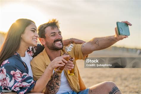 Affectionate Young Couple Taking Selfies While Enjoying Beer Stock