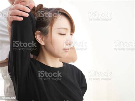 A Japanese Woman Getting A Shoulder Massage At A Seitai Clinic Stock