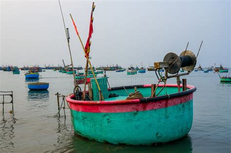 Traditional Round Vietnamese Basket Boat Floating In A Crowded Harbor