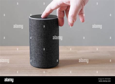 Hand Pushing Button On Smart Speaker Turning Or Switching Off