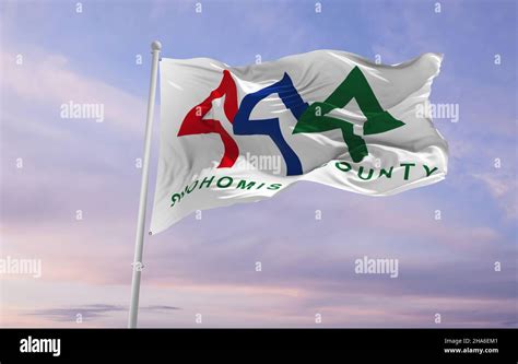 Flag Of County Snohomish Washington Usa At Cloudy Sky Background On