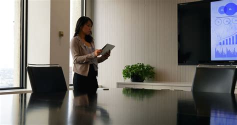 businesswoman using tablet during office presentation