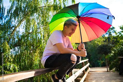Non Binary Gender Non Binary Androgynous Person With A Gay Pride Umbrella He Is Smiling And