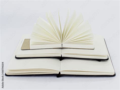 Three Unfold Notebooks Lie On Top Of Each Other Pyramid Of Books Small Fan Open Notepad With