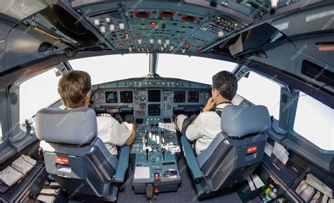 Premium Photo Pilots In An Airplane Cockpit