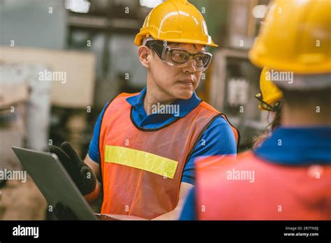 Professional Engineer Worker Male Asian Working With Teammate As Machine Programmer In Metal